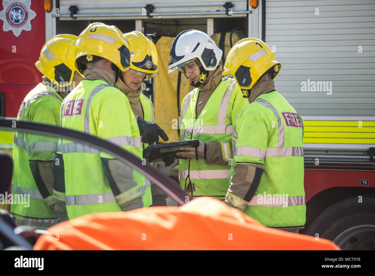 Group of firemen on rescue job using handheld tablet at work Stock ...