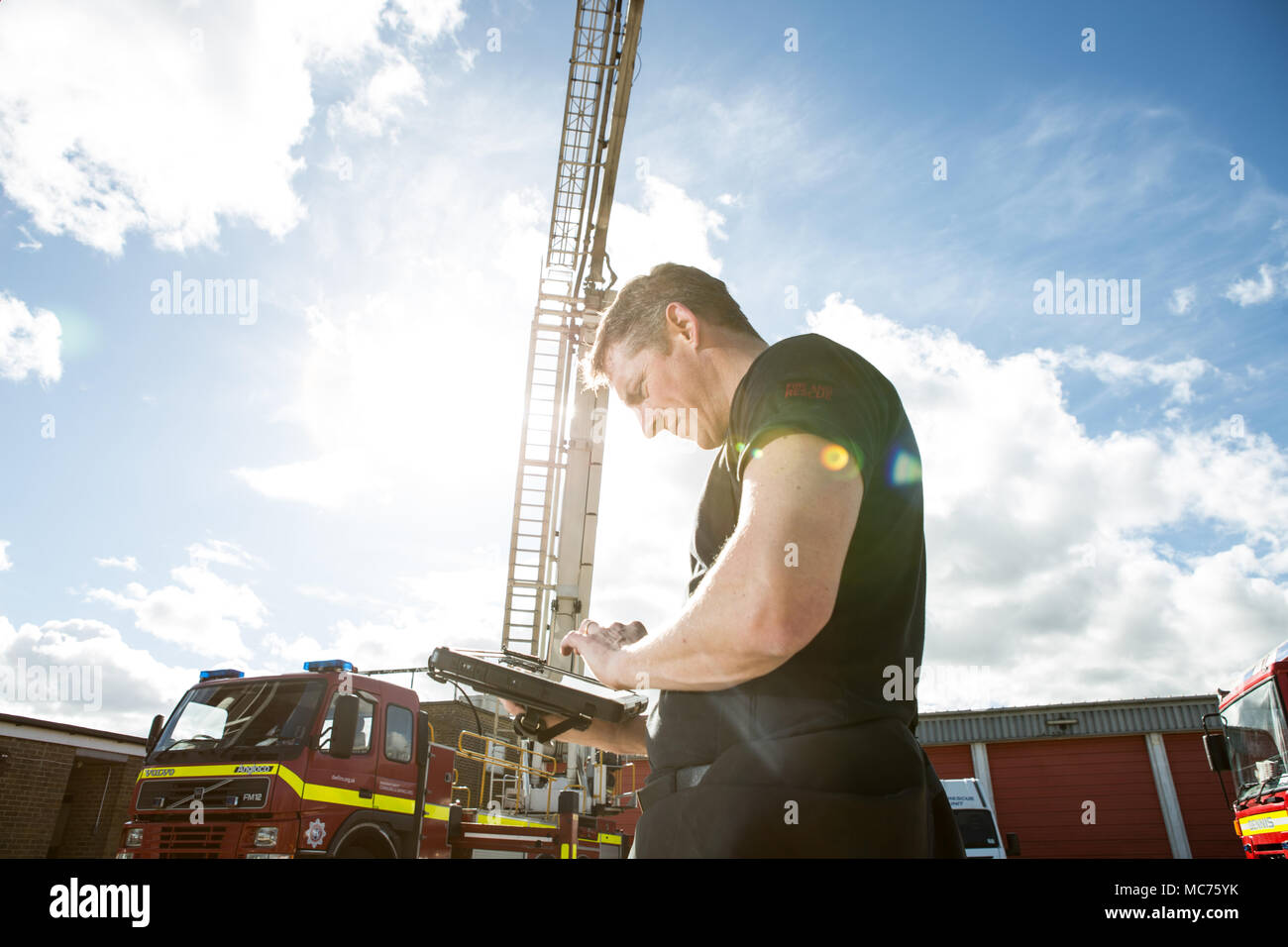 Male Firefighter using tech at work Stock Photo - Alamy