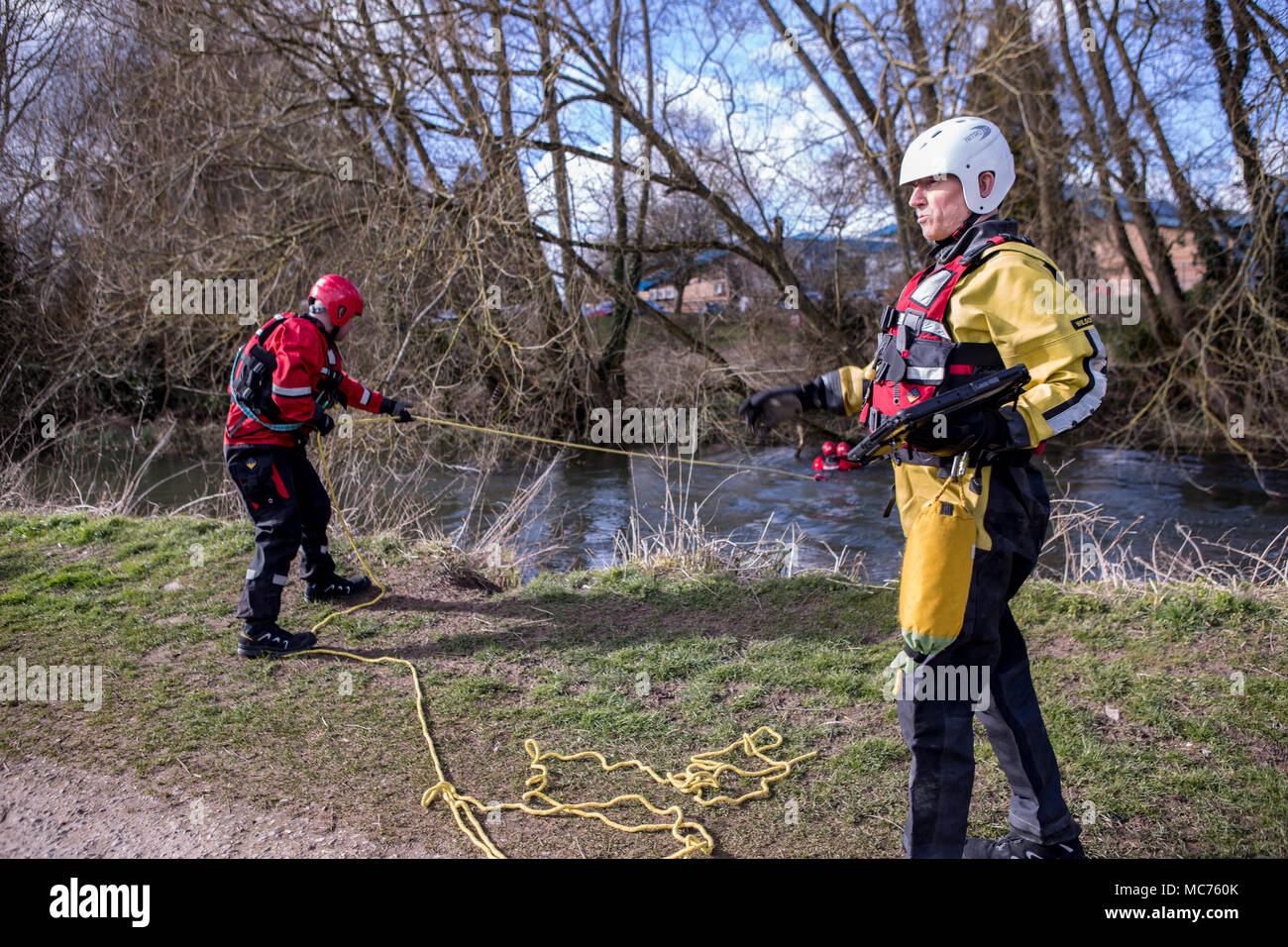 Fire fighters during a river rescue operation pulling someone from ...