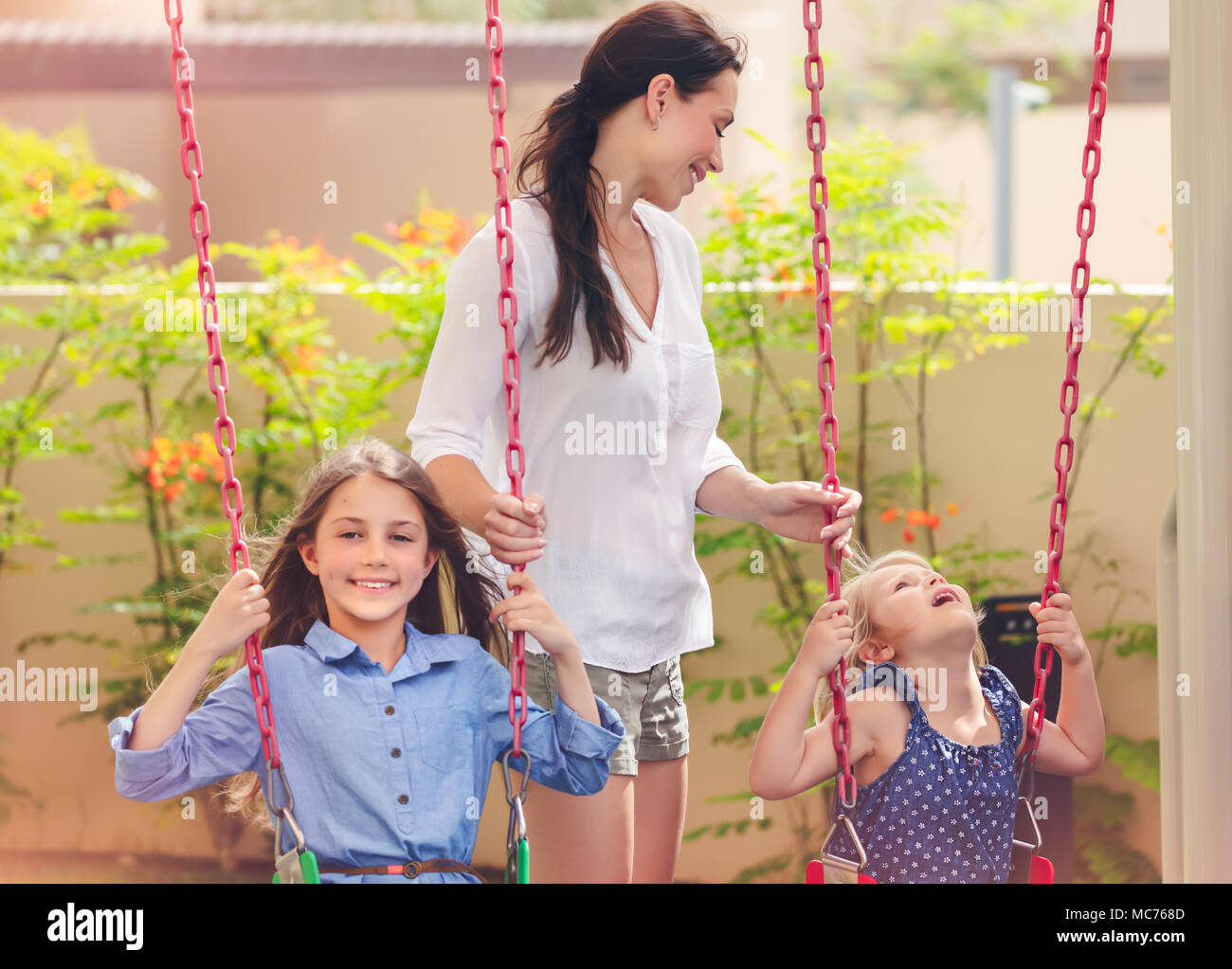 Sisters On A Swing Stock Photos & Sisters On A Swing Stock Images - Alamy