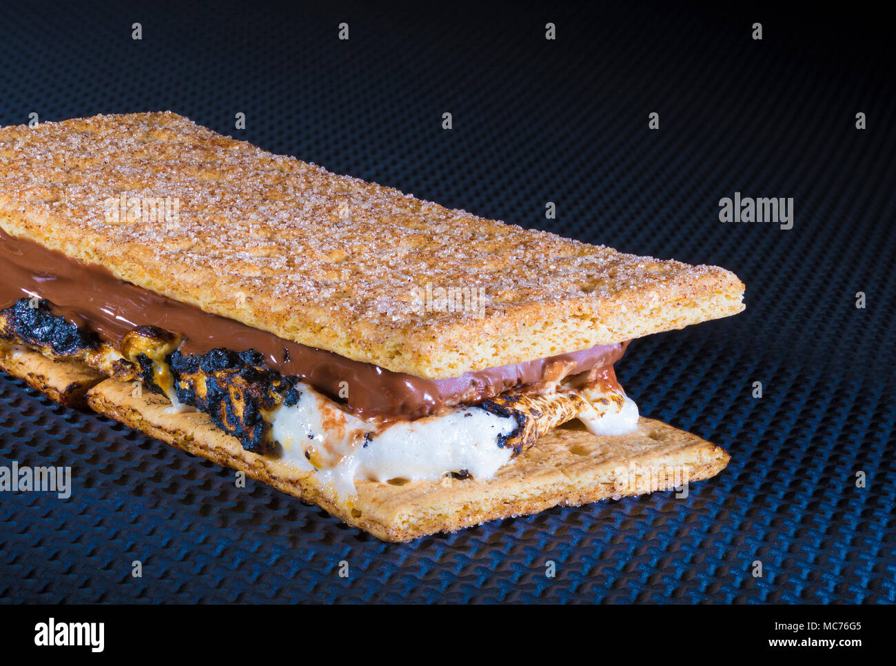 Smore that is ready for campers to eat on a textured background Stock ...