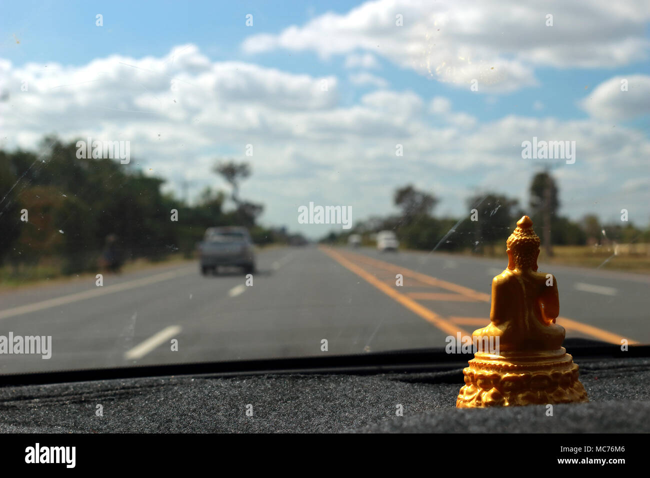 Mini buddha in front of the car Stock Photo - Alamy