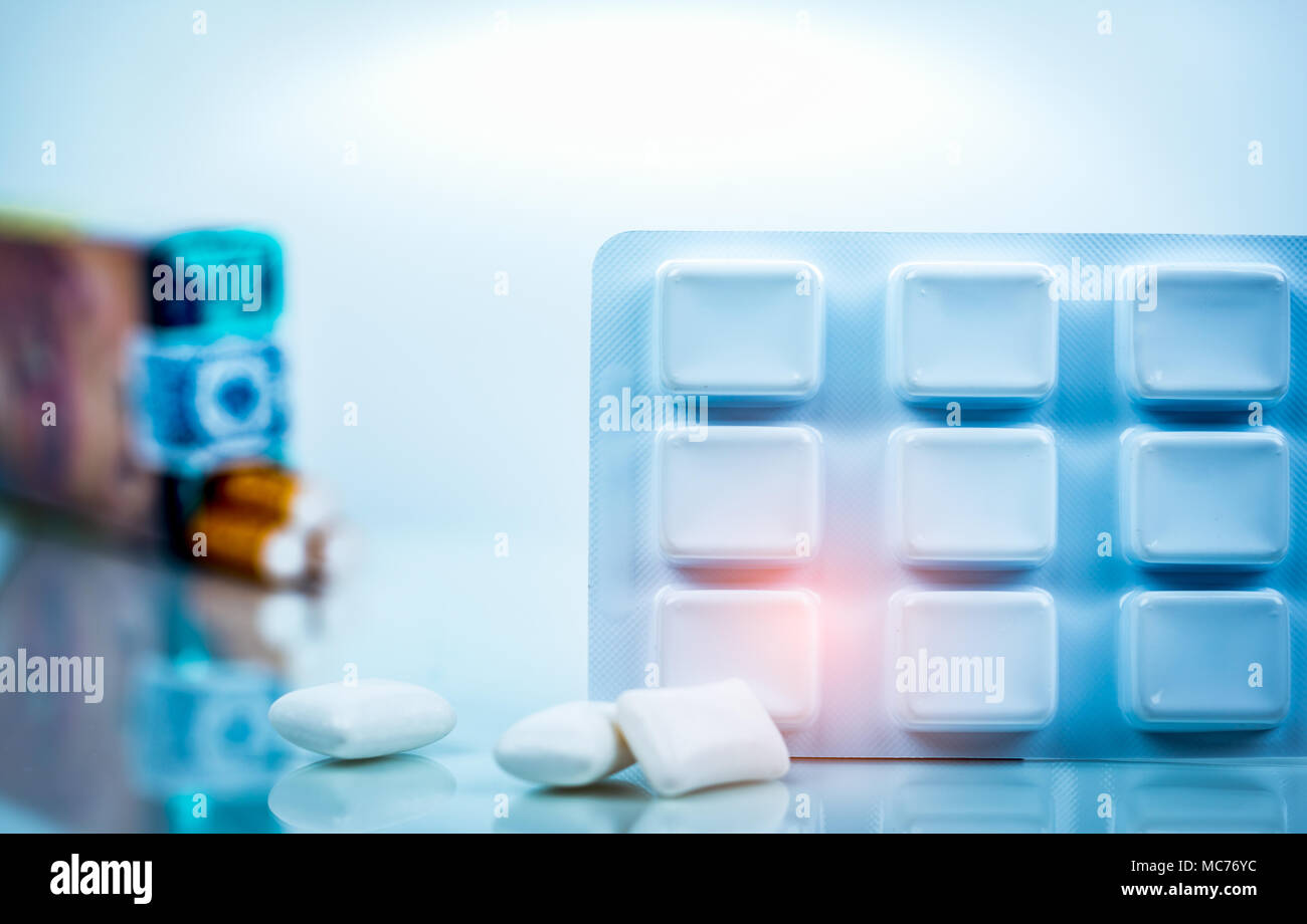 Nicotine chewing gum in blister pack on blurred background of cigarette ...