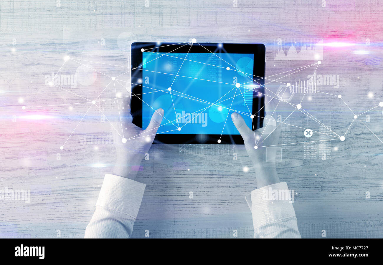 Hand using tablet with linking graphs charts report and informational ...