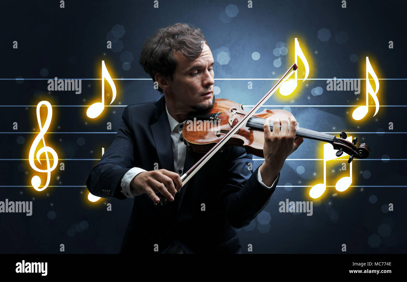 Young handsome fiddler playing with music sheet background Stock Photo ...