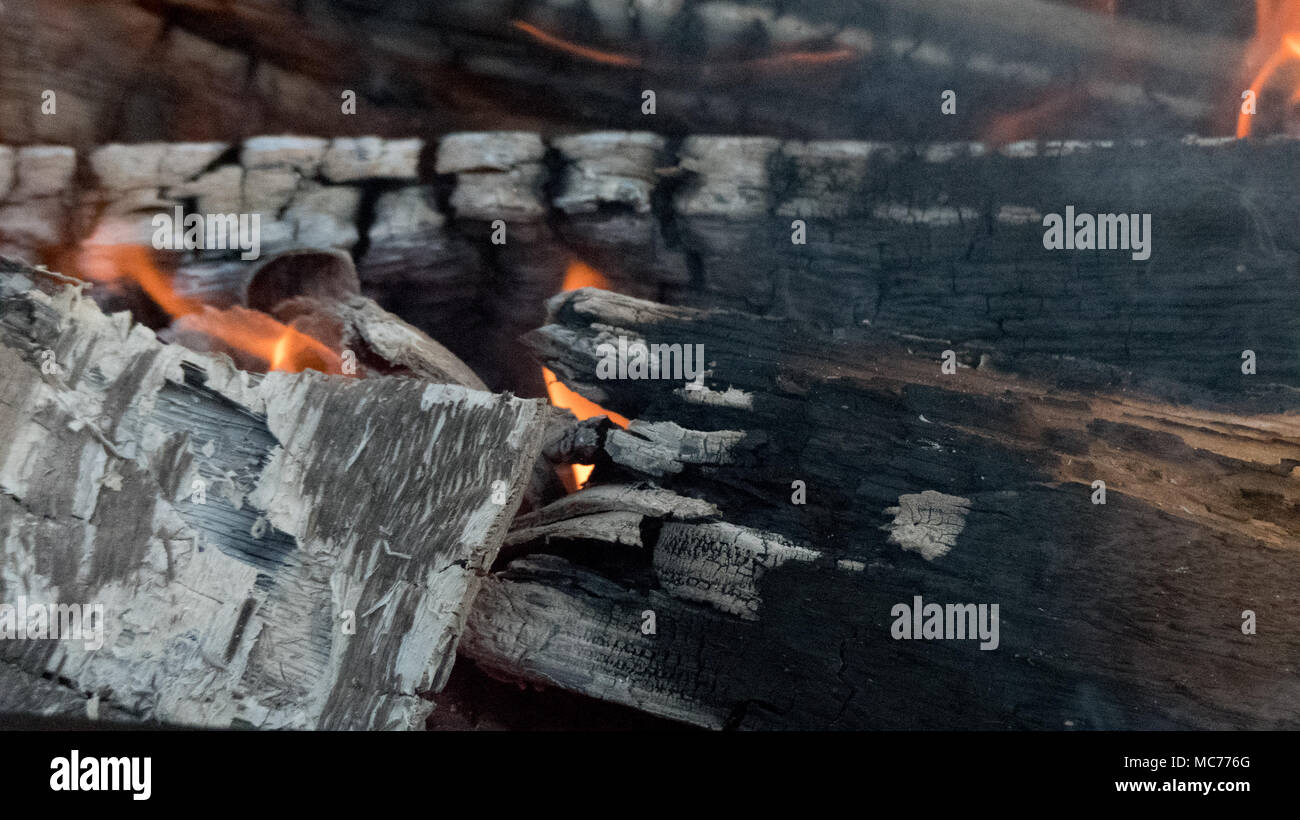 Burnt wood pieces glowing close up abstract backdrop Stock Photo - Alamy