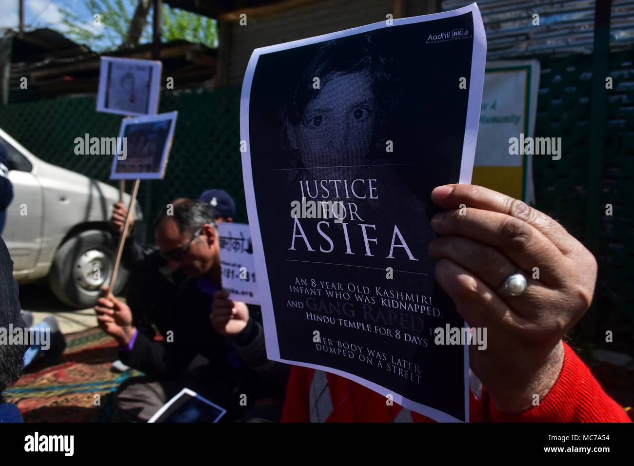 A protester holds a placard demanding capital punishment for the ...