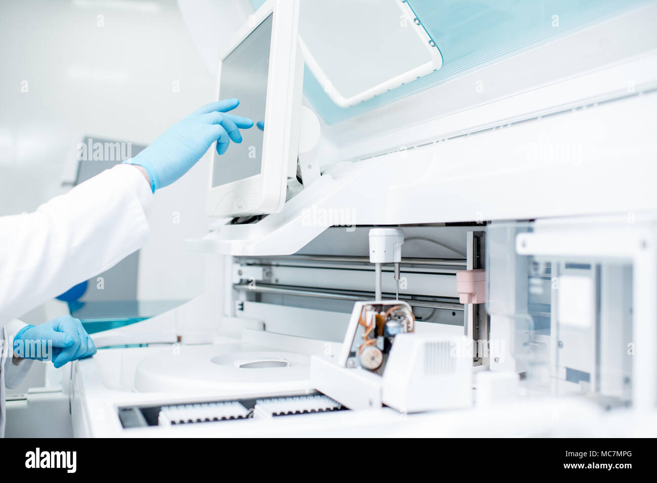 Touching the screen of the medical analizer machine at the laboratory ...