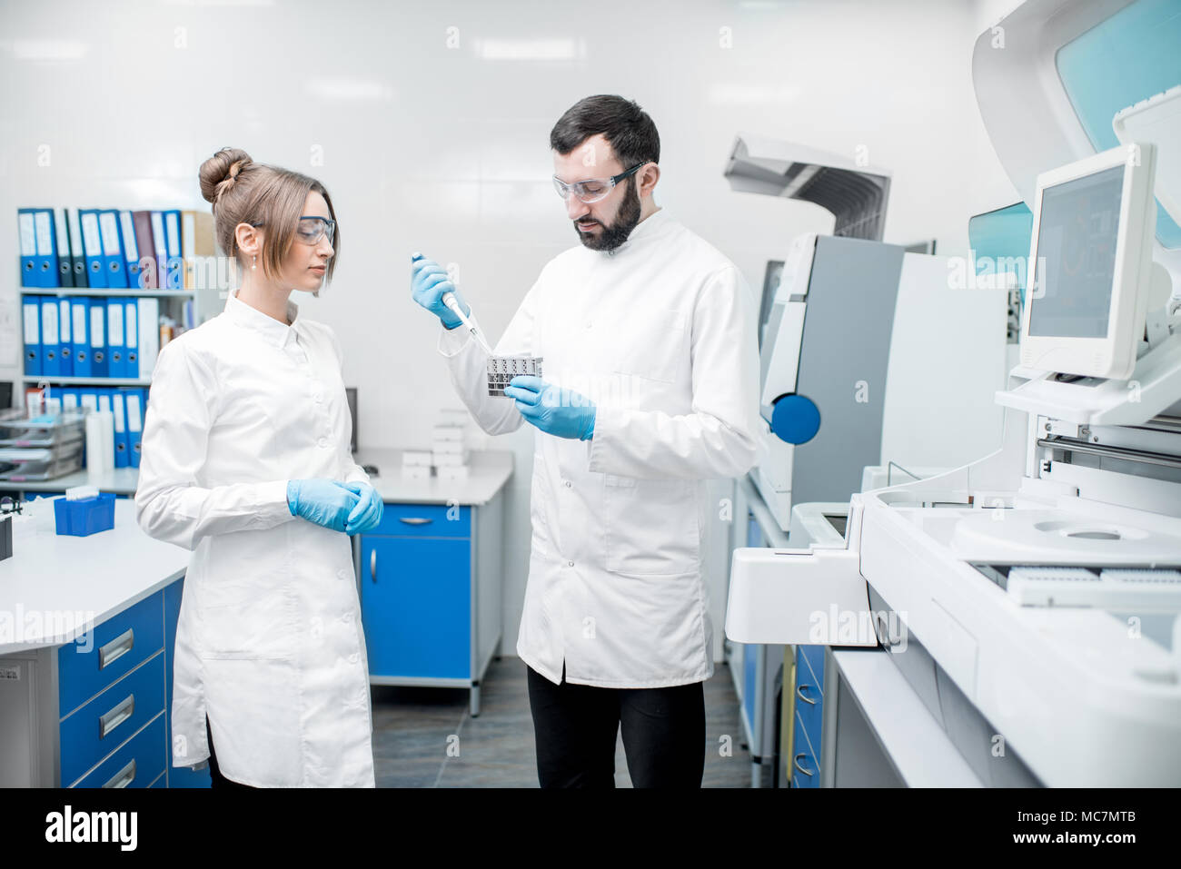 Doctor working biochemistry analyzer in hi-res stock photography and ...
