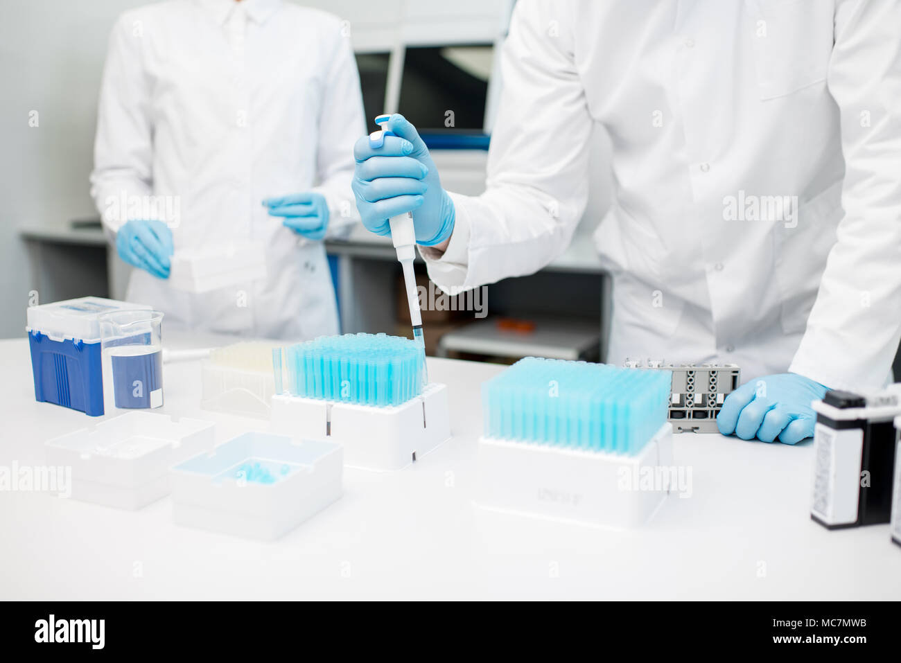 Laboratory assistants working with test tubes in the laboratory, close ...