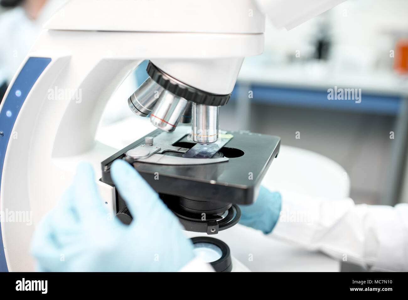 Scientists looking sample microscope hi-res stock photography and ...