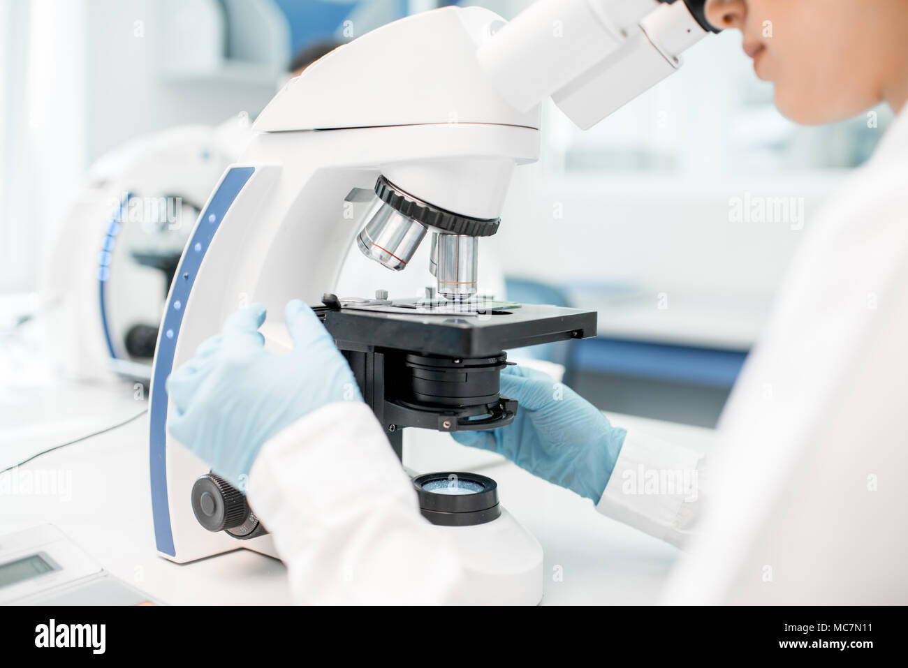 Scientists looking sample microscope hi-res stock photography and ...