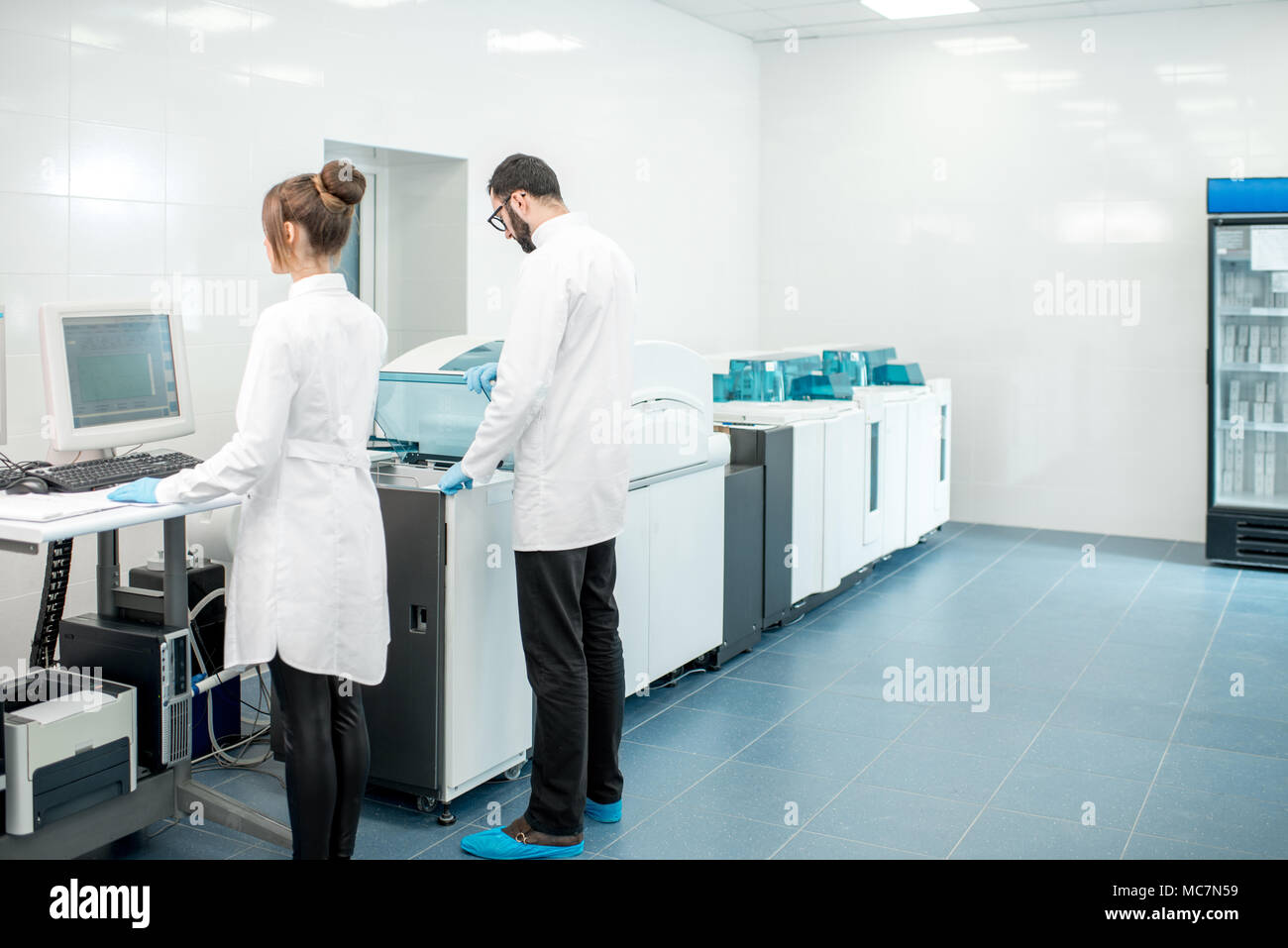 Doctor working biochemistry analyzer in hi-res stock photography and ...