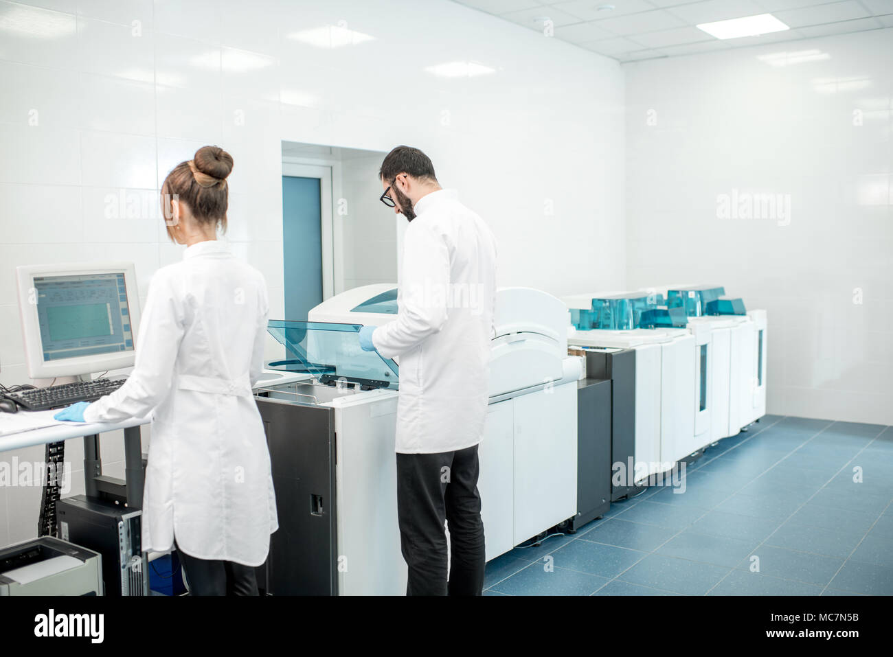 Doctor working biochemistry analyzer in hi-res stock photography and images - Alamy