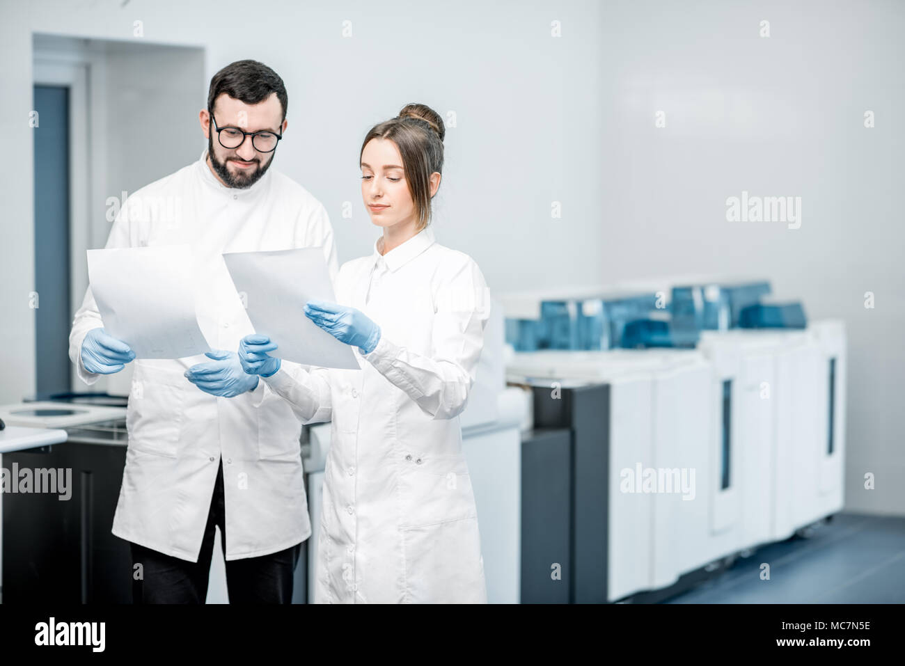Doctor working biochemistry analyzer in hi-res stock photography and ...