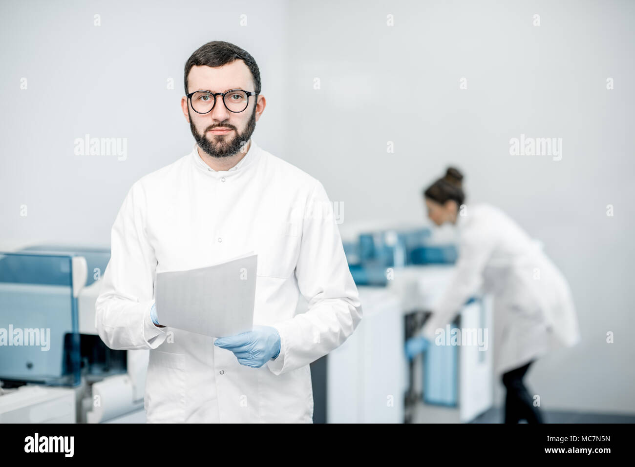 Doctor working biochemistry analyzer in hi-res stock photography and ...