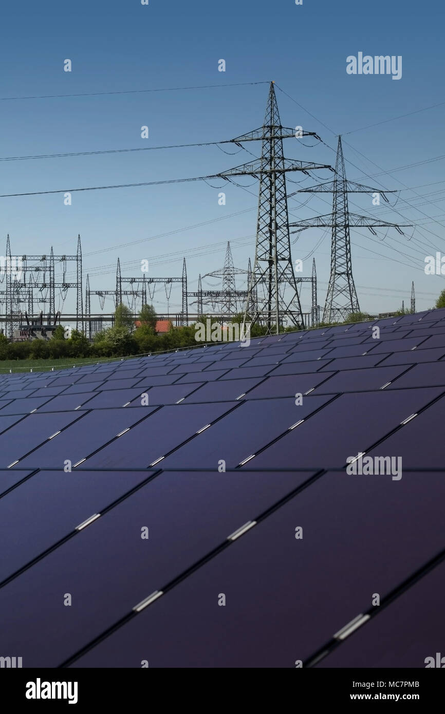 Solar power plant. Solar panels in the foreground, transformer station ...
