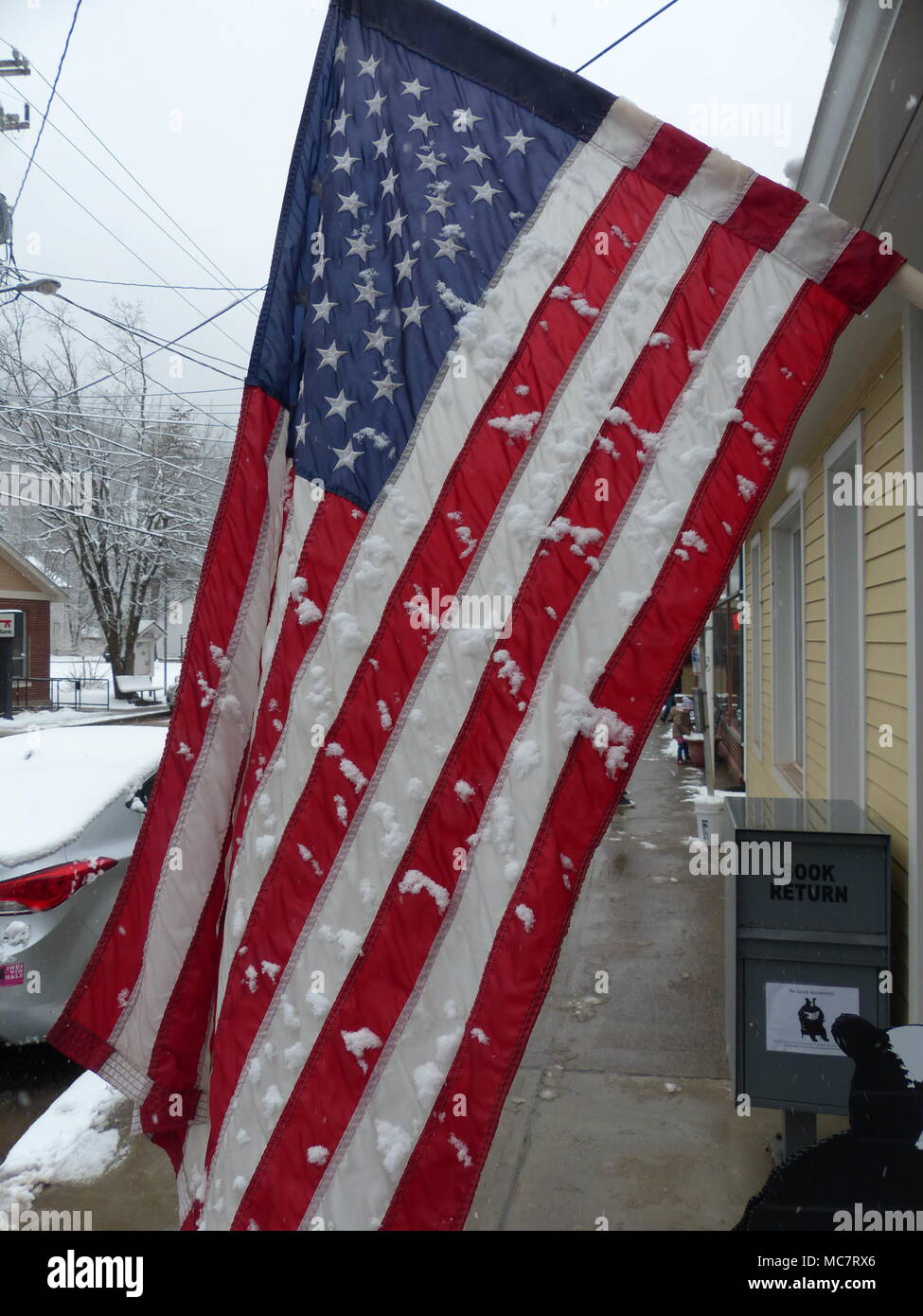US flag after snow storm Stock Photo - Alamy