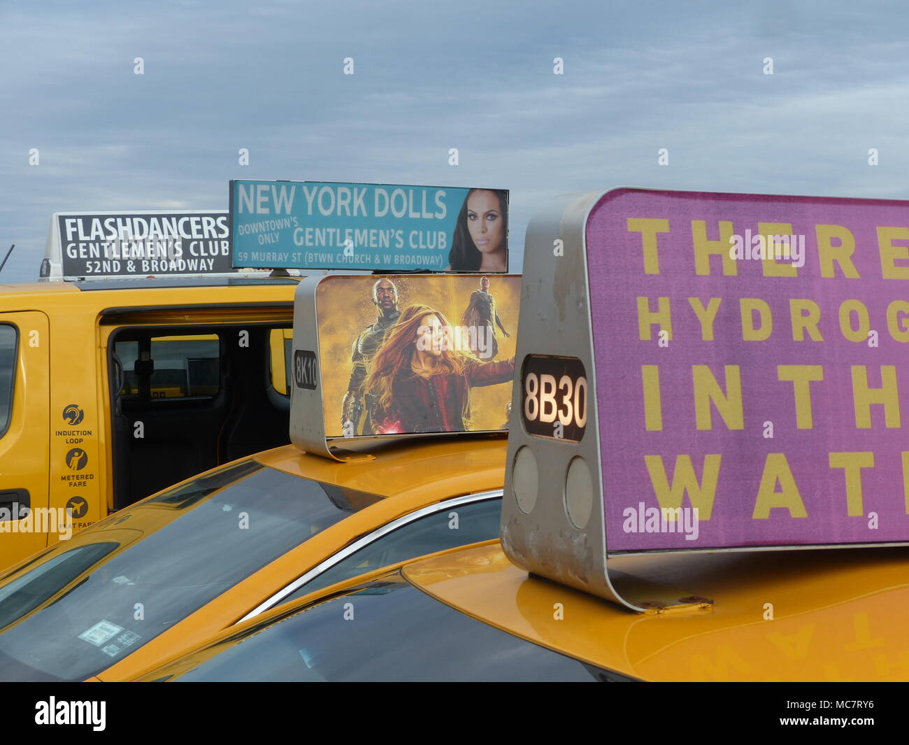 NYC taxis with rooftop advertisement waiting at JFK Central Holding Lot ...