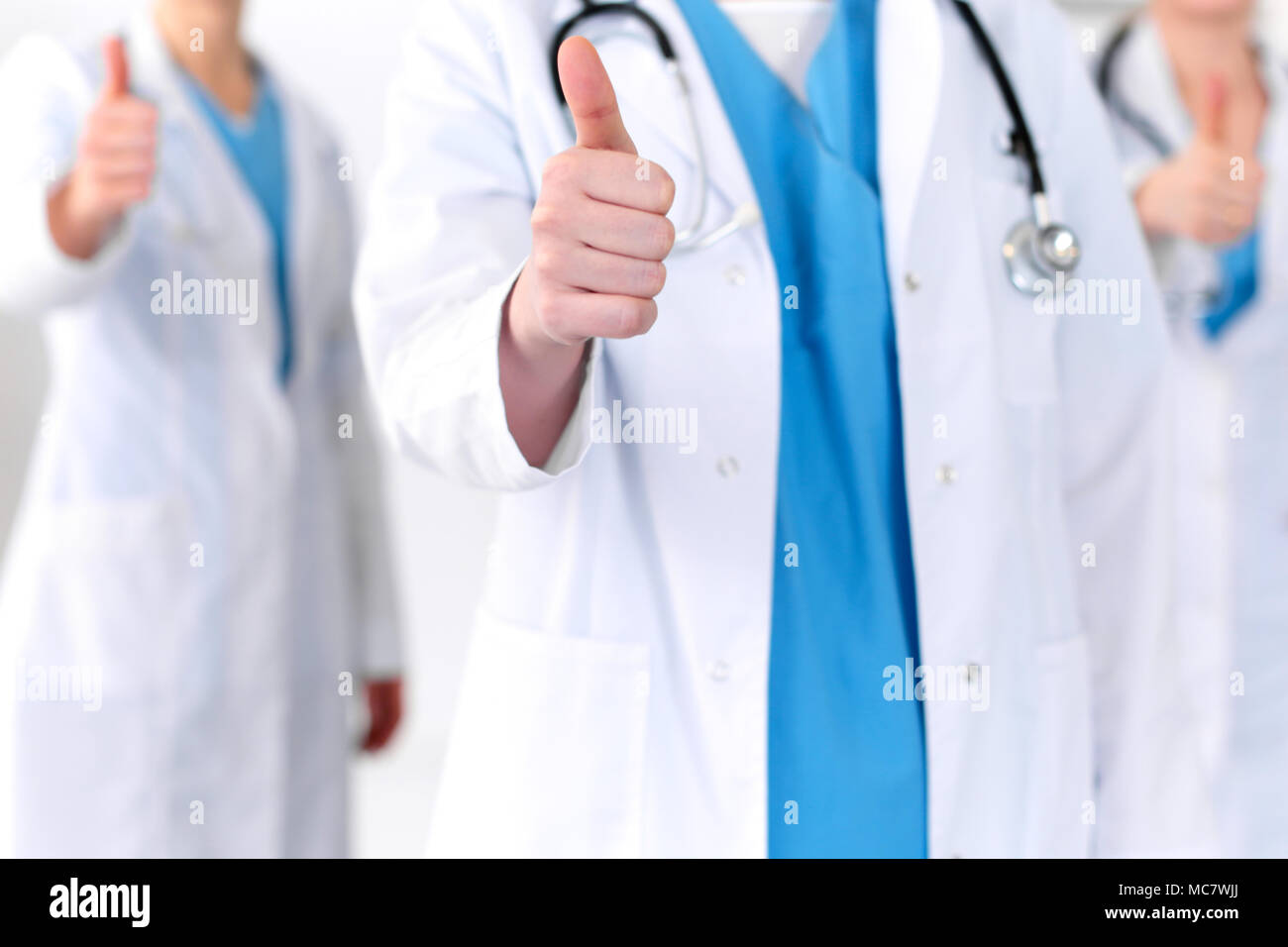 Groupe of medicine doctors show OK sign with thumb up close up. Success ...