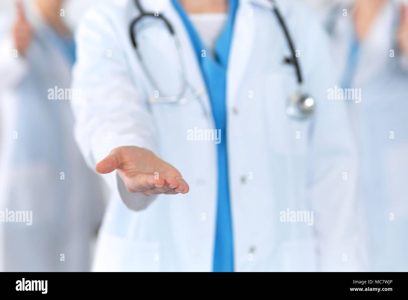 Group of medicine doctors offering helping hand for shaking hand or ...