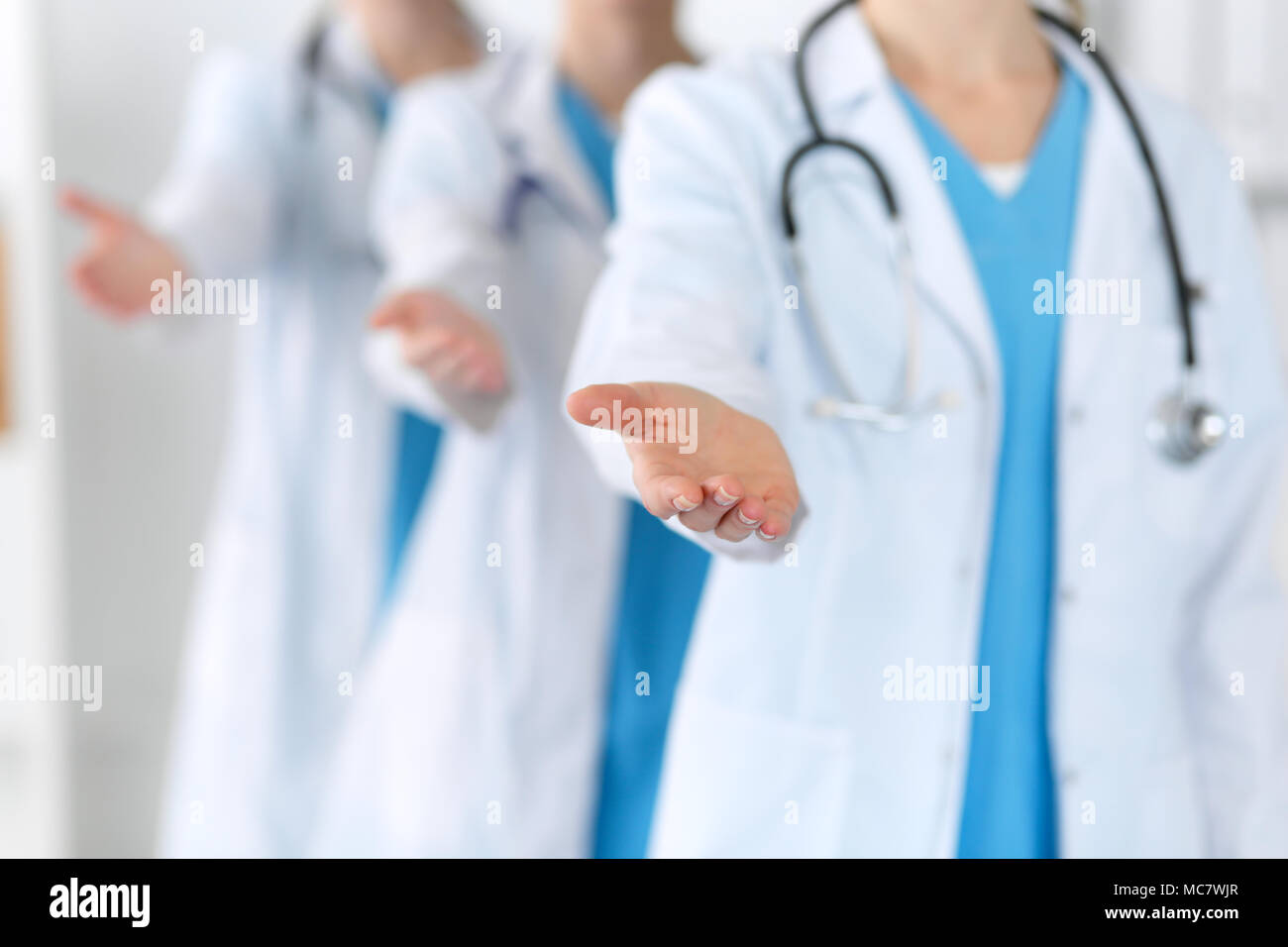 Group of medicine doctors offering helping hand for shaking hand or ...