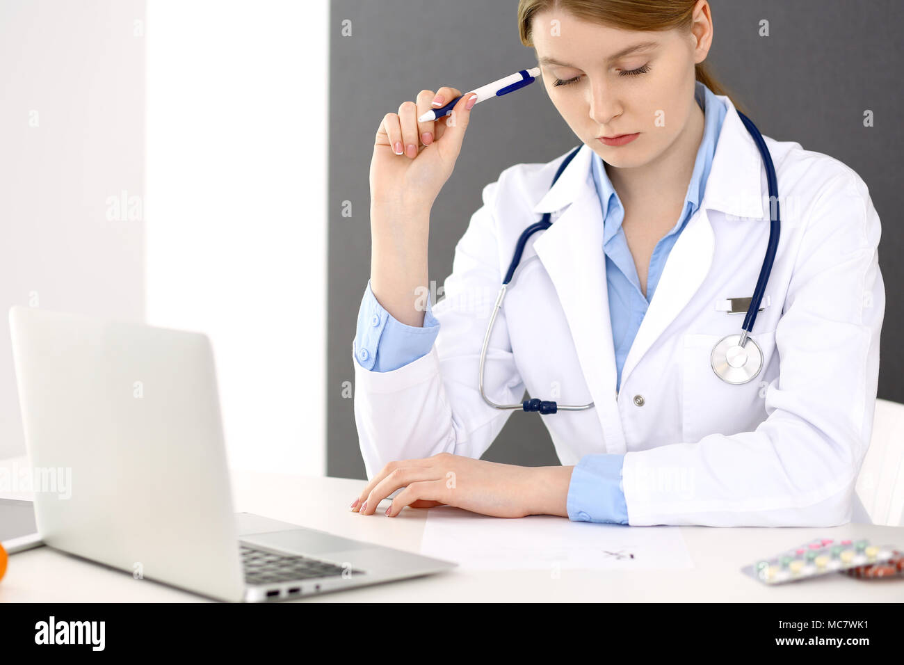 Female doctor filling up medical form on clipboard closeup. Physician ...