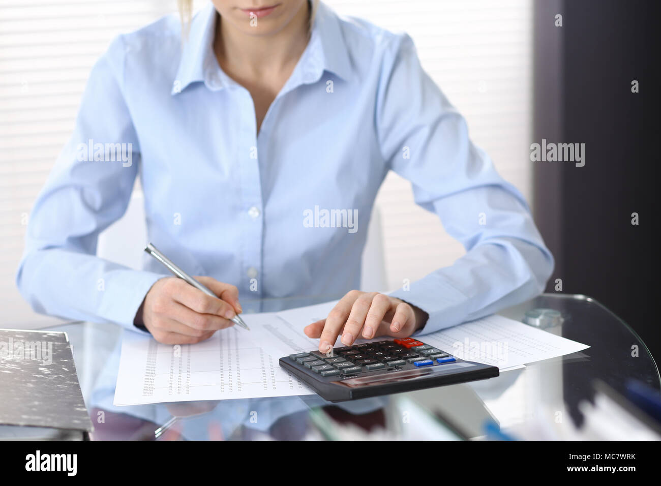 Female bookkeeper or financial inspector making report, calculating or ...