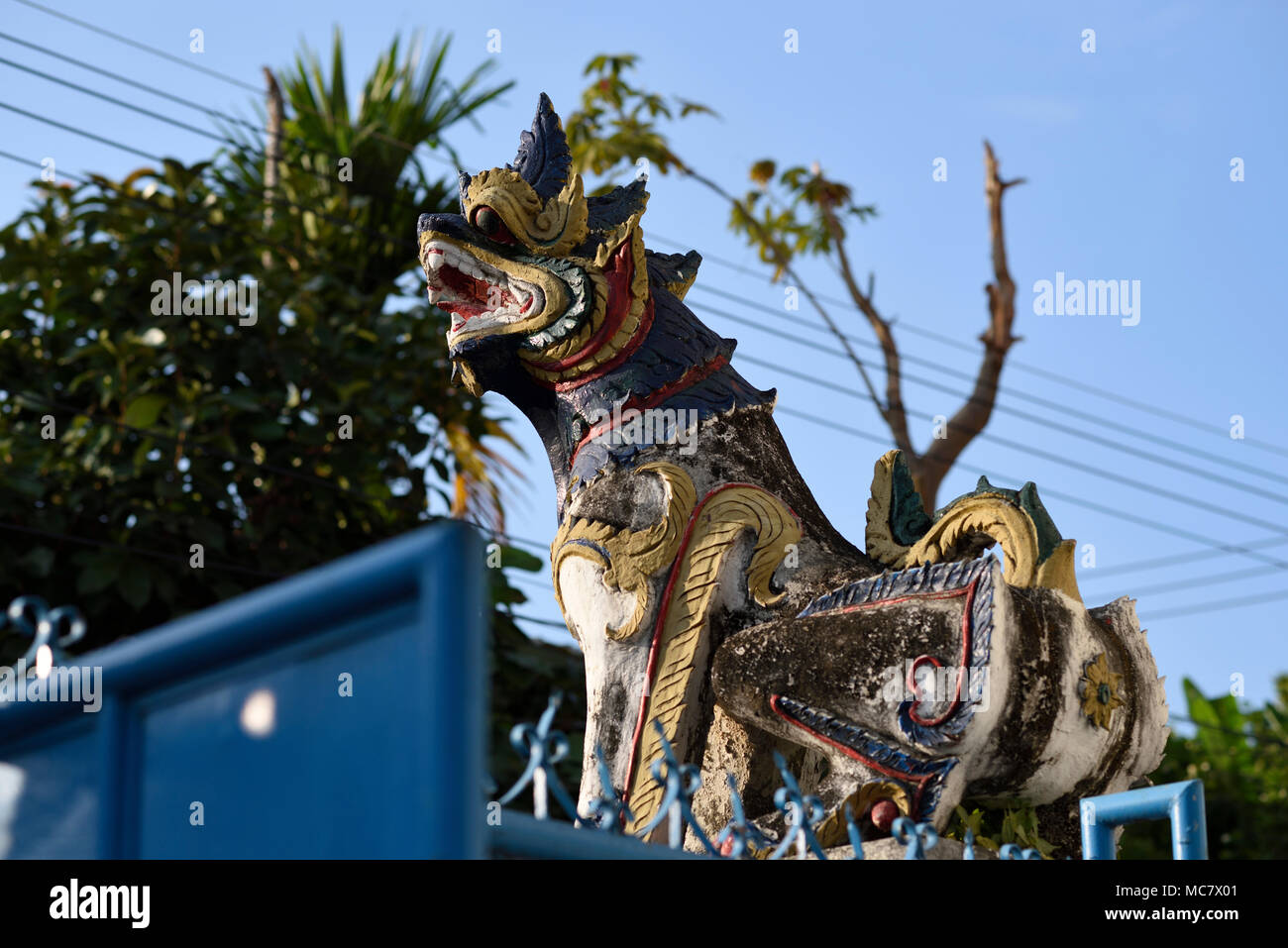 Thai Singha lion statue in front of many cables, Chiang Mai, Thailand ...