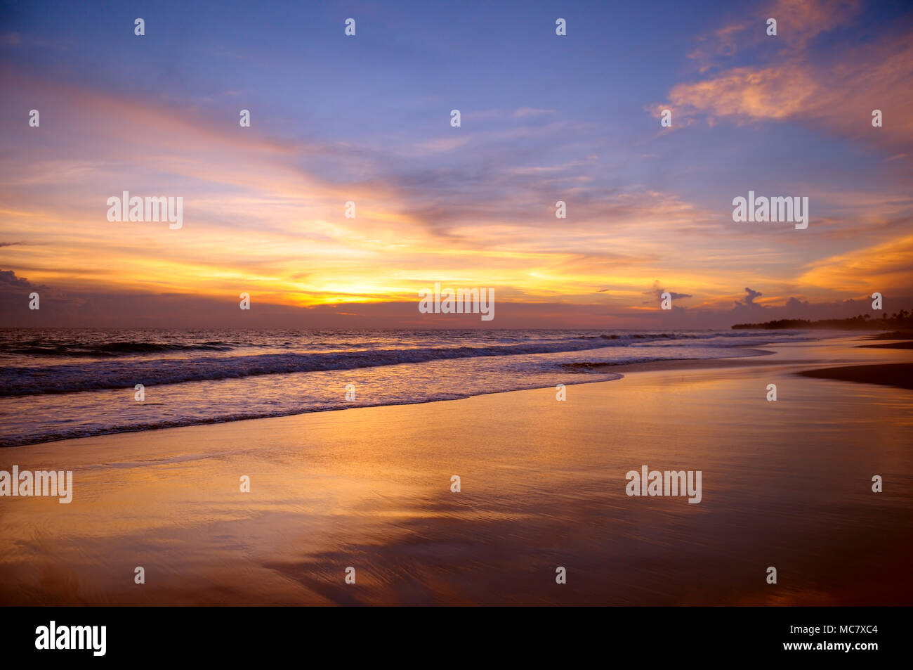 sandy beach and a beautiful sunset Stock Photo - Alamy