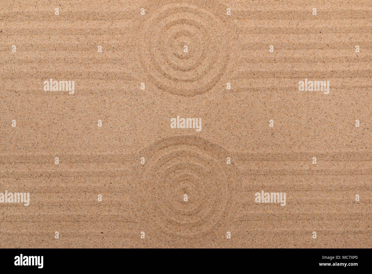Two concentric circle and lines on the sand, with a place for designer ...