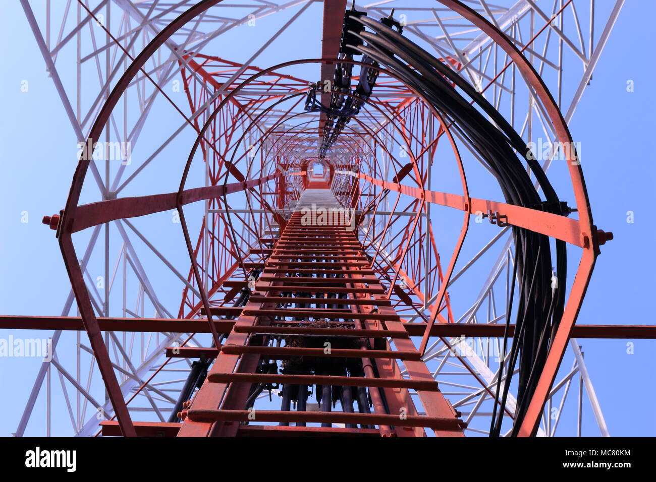 The photograph offers an upward perspective of a telecommunications ...