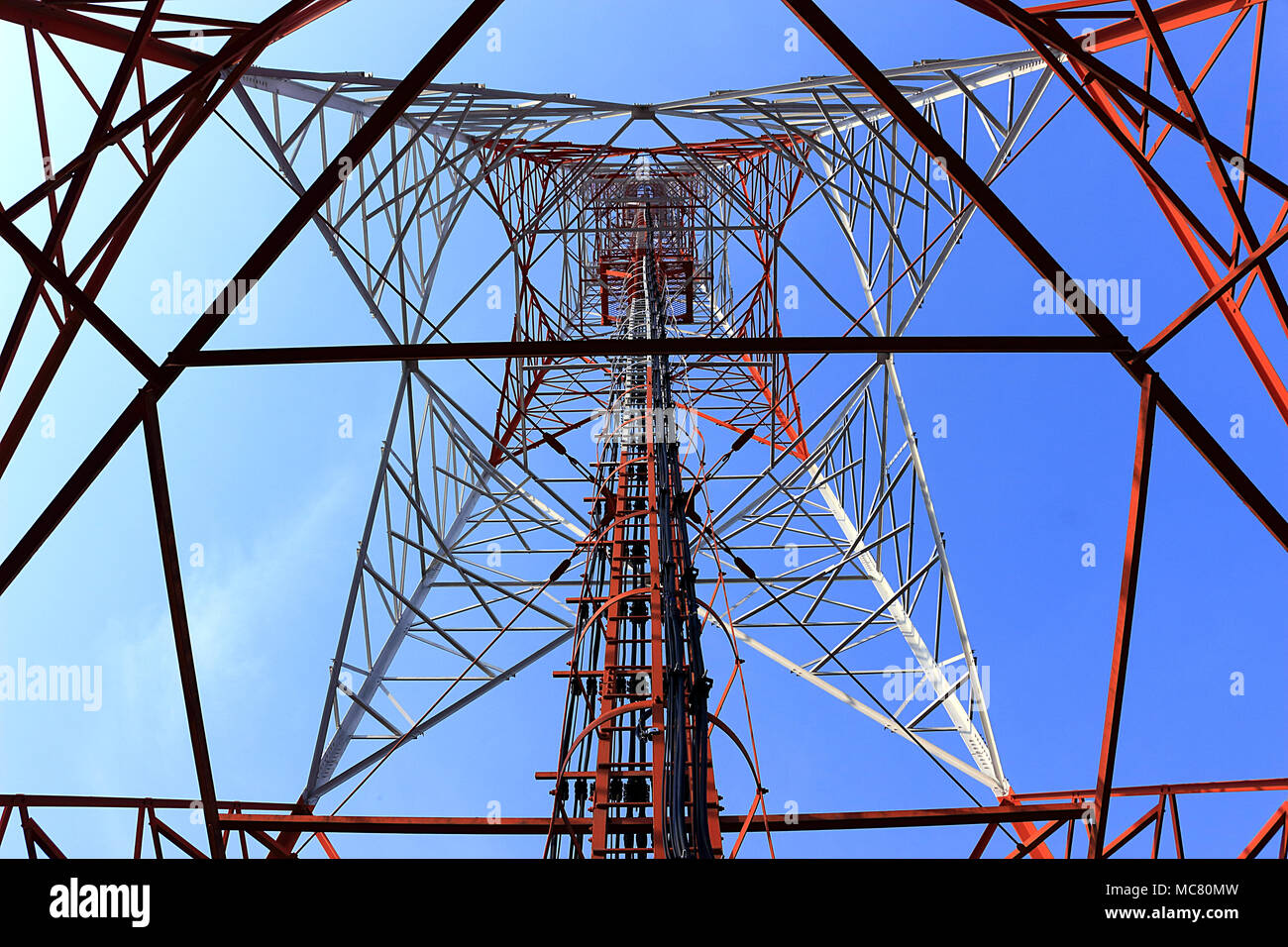 The photograph offers an upward perspective of a telecommunications ...
