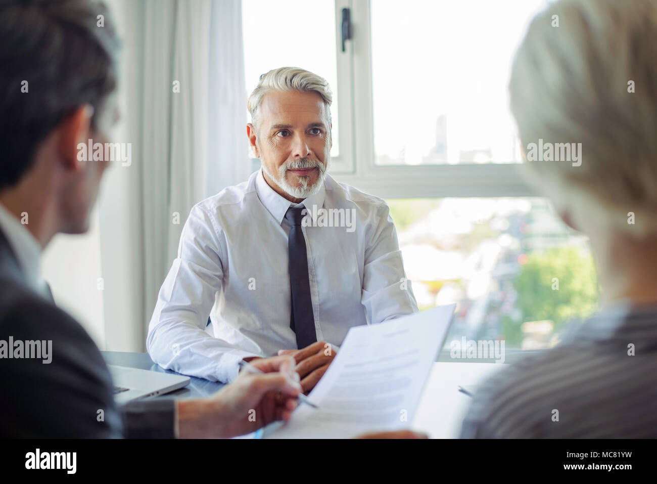 Businessman with clients Stock Photo - Alamy