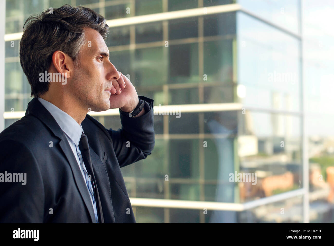 Man looking through window in high rise building Stock Photo - Alamy