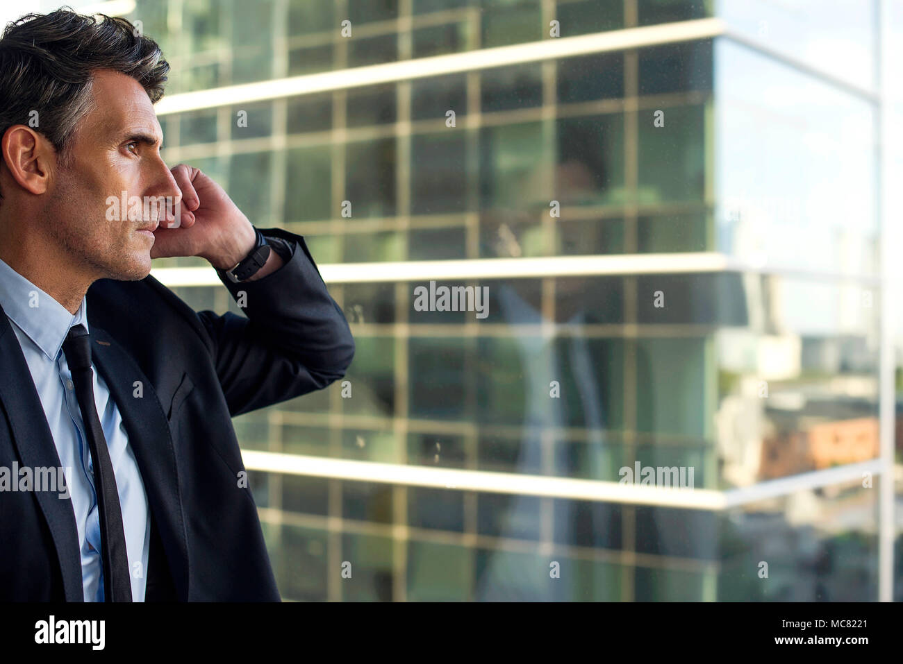 Man looking through window in high rise building Stock Photo - Alamy