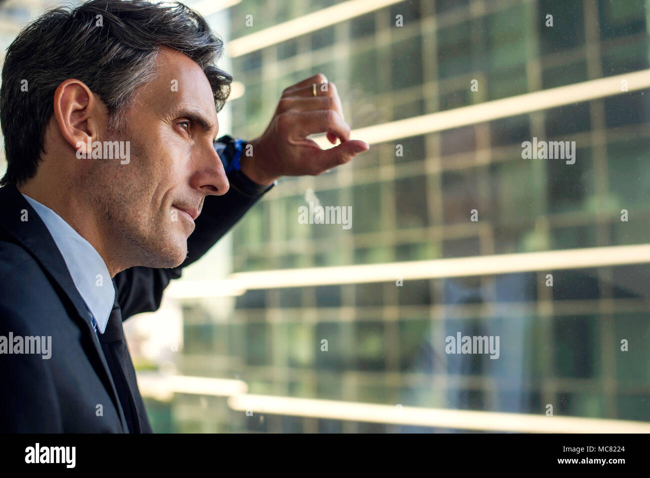 Man looking through window in high rise building Stock Photo - Alamy