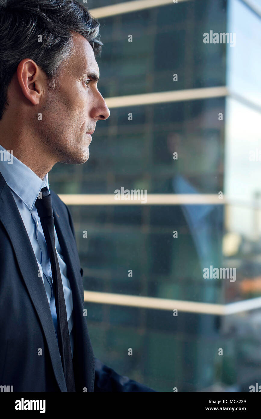 Man looking through window in high rise building Stock Photo - Alamy