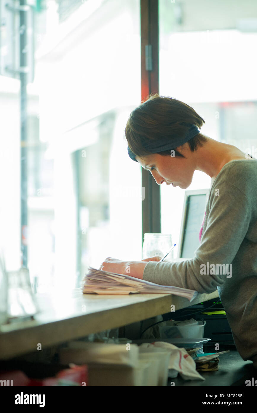 Cafe manager concentrating on work Stock Photo - Alamy