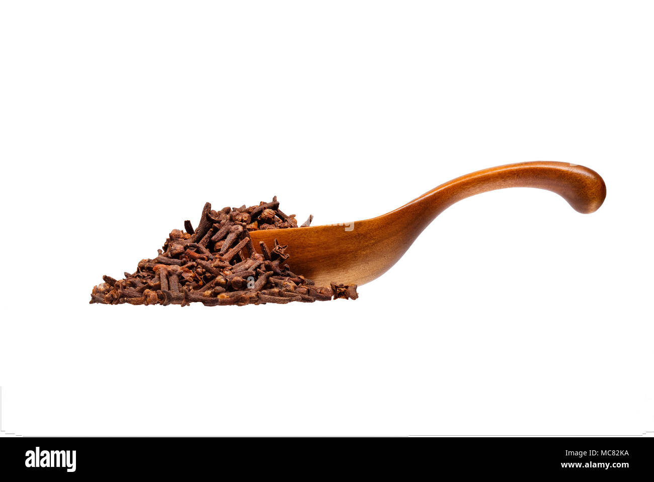 Dried cloves in the wooden spoon, isolated on white background Stock ...