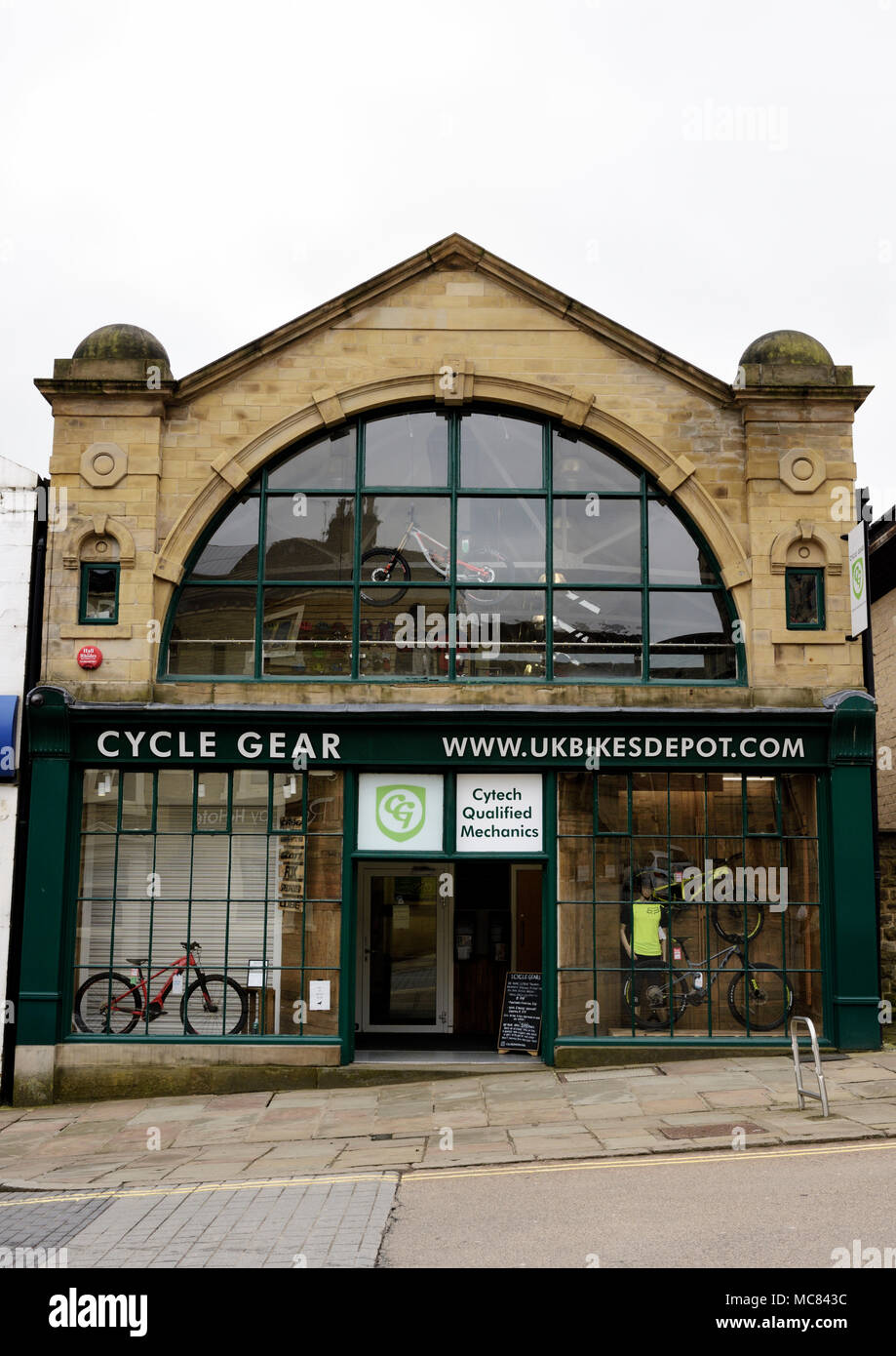 Cycle shop building facade with two large windows on ground floor and ...