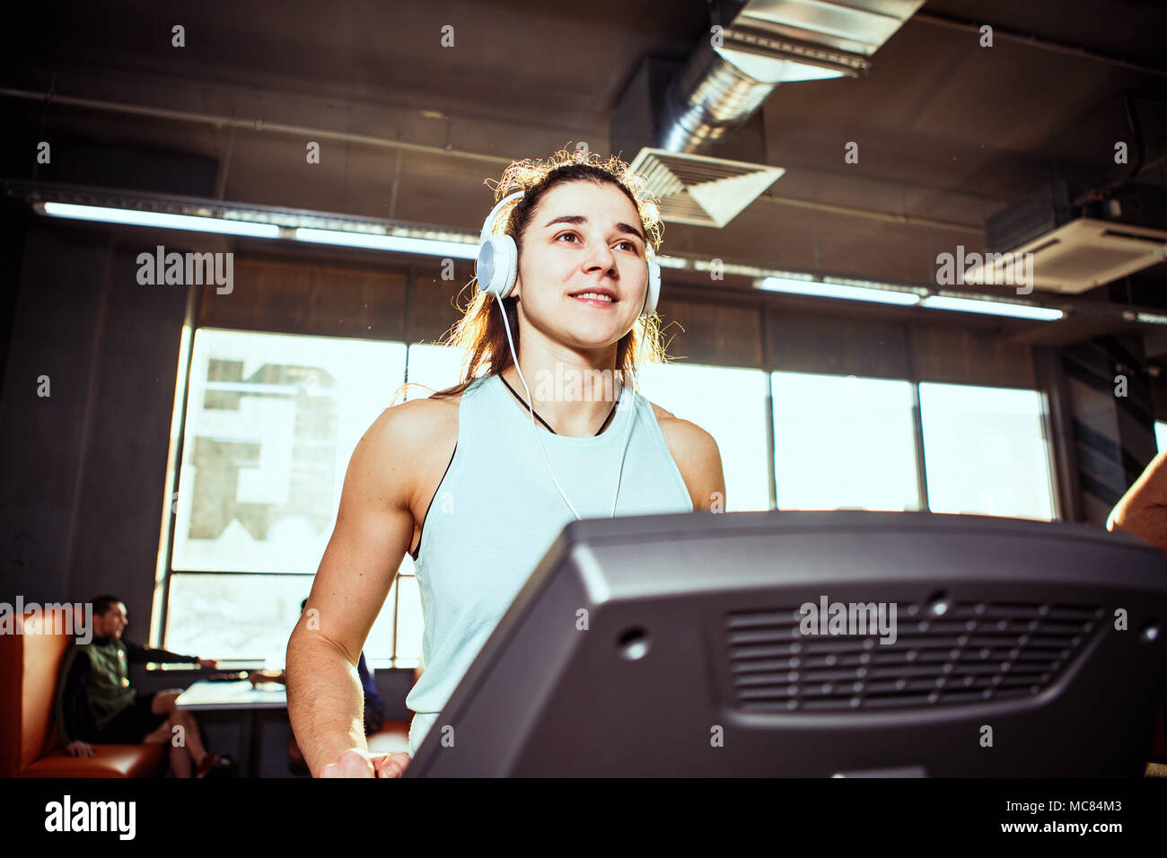 Theme is sport and music. A beautiful inflated Caucasian woman running ...