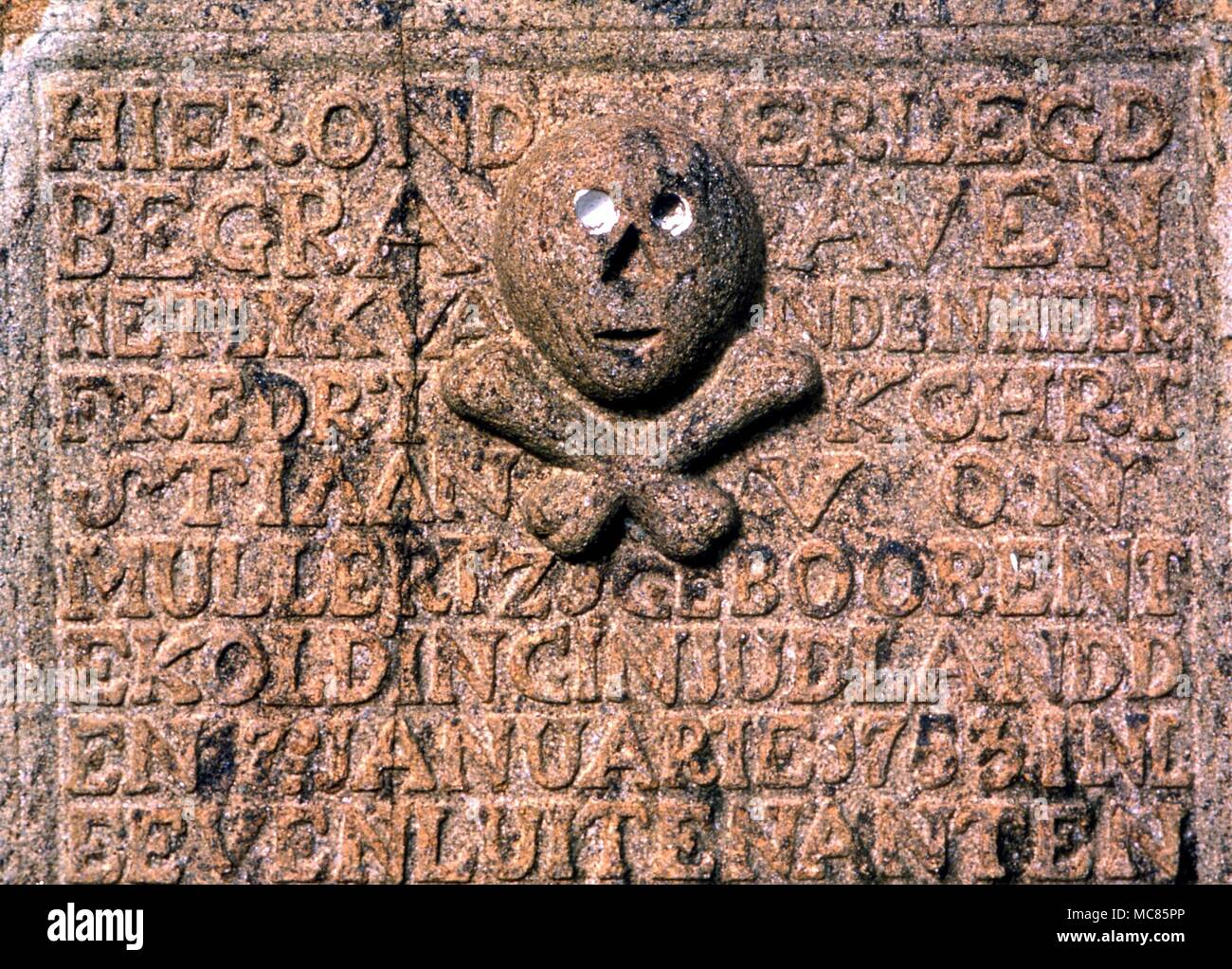 GRAVEYARD Skull and crossbones on an 18th century Dutch gravestone, in ...