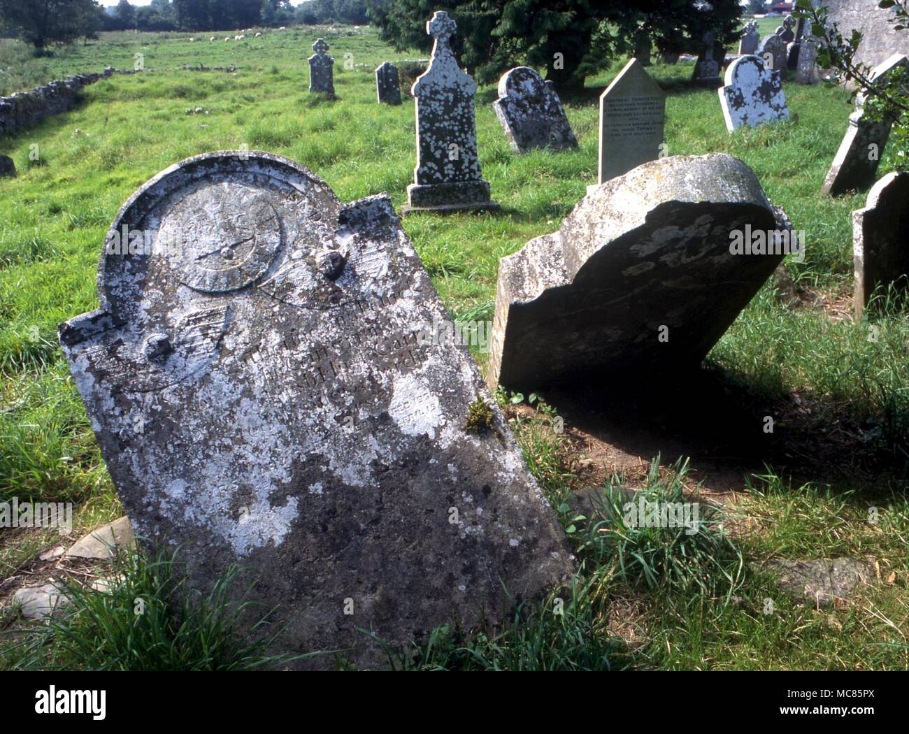 GRAVEYARD Tombstones in the churchyard of the 15th century church of ...