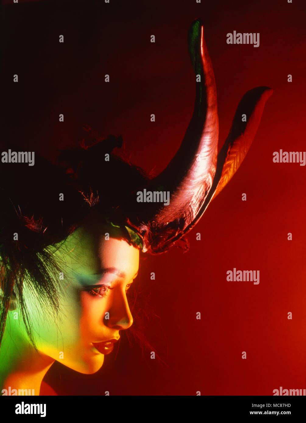 Female manniken wearing a pair of goat-horns which were used in magical ...