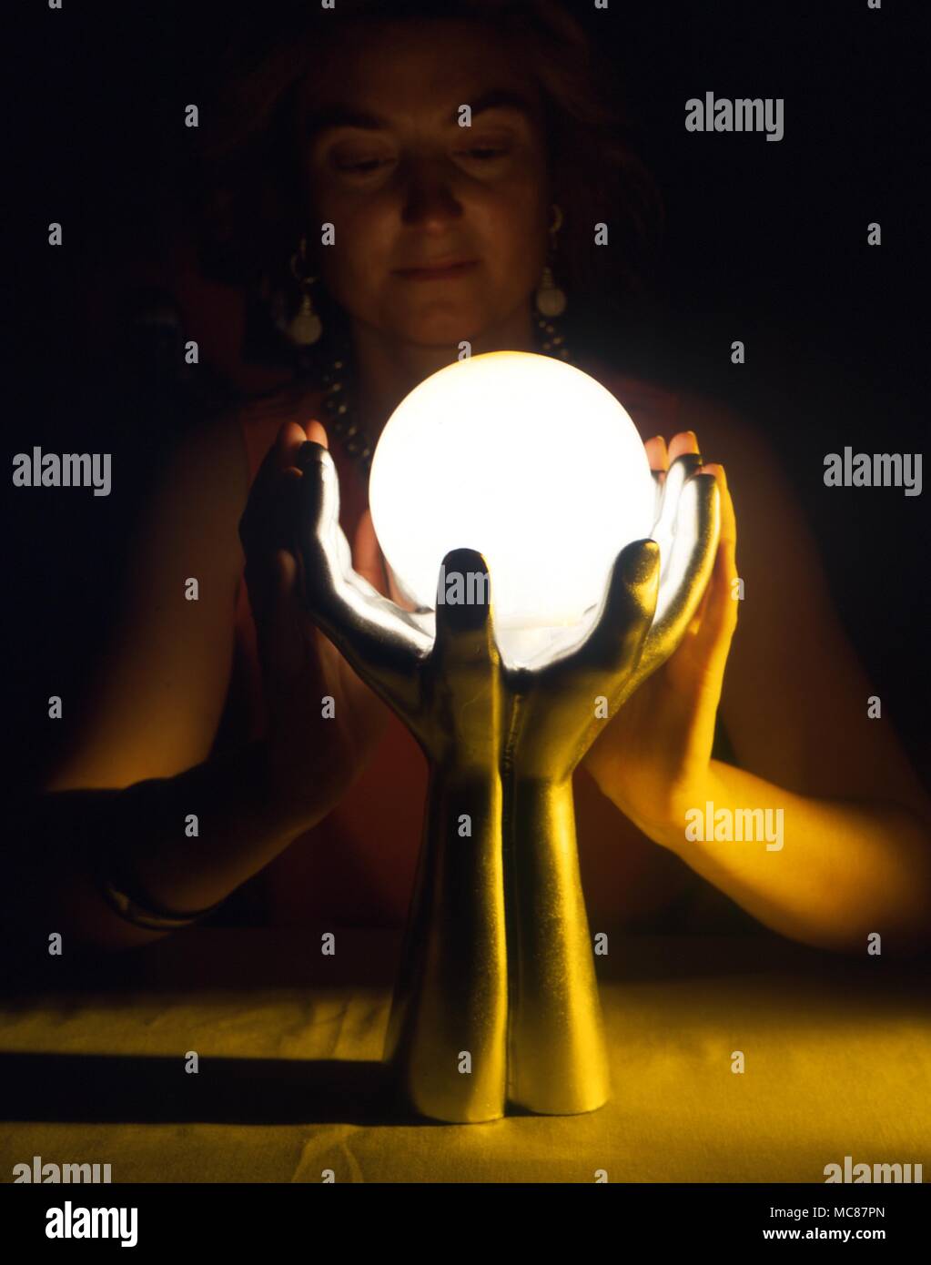 Crystal Reading women using a lighted crystal ball as a scrying glass ...