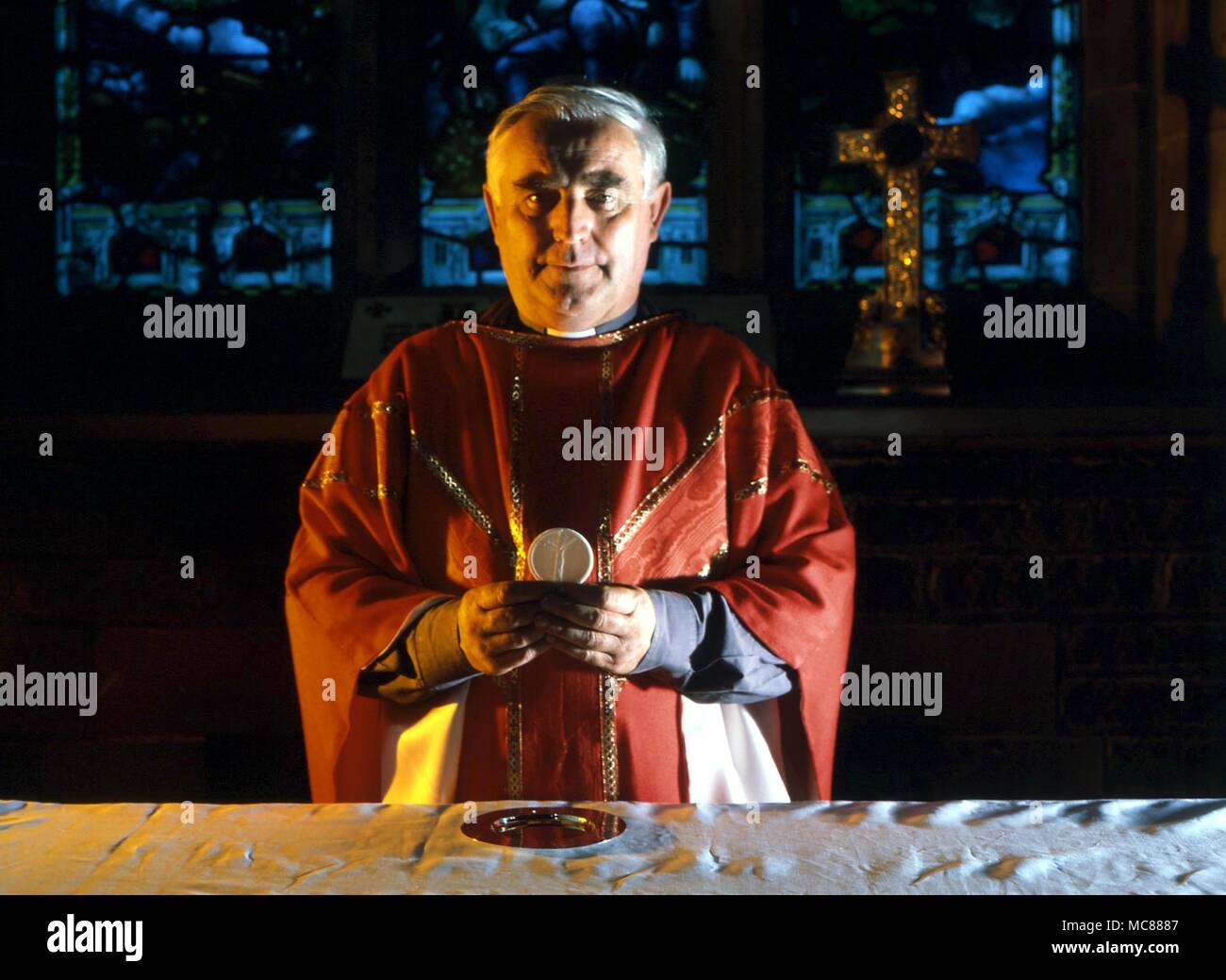 CHRISTIAN Priest of an Anglican Church celebrating the Mass. He is in ...