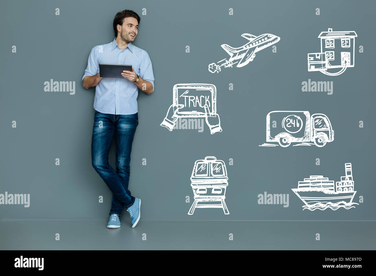 Young progressive man smiling while booking transport online Stock ...