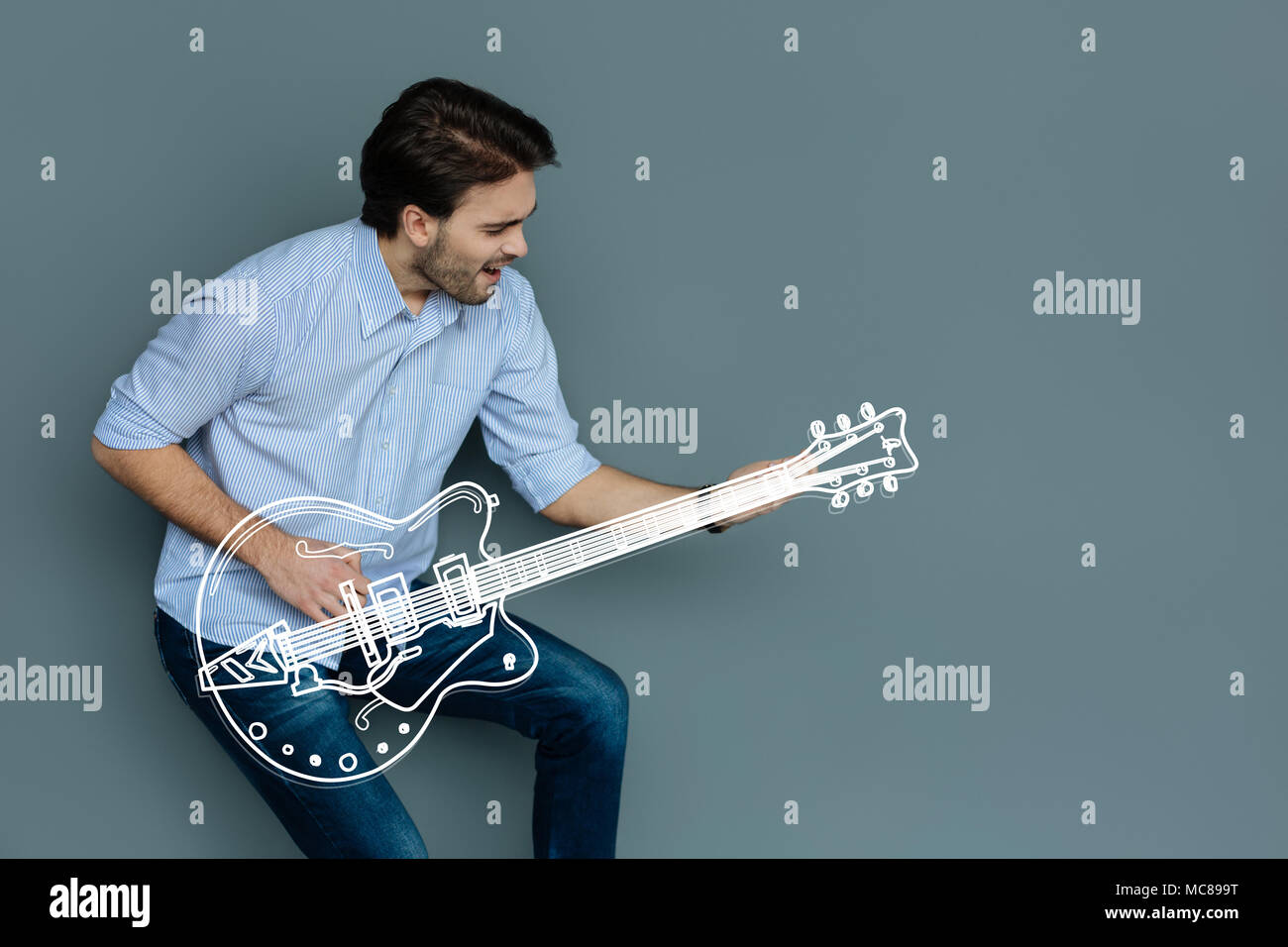 Expressive young male practicing guitar hi-res stock photography and ...