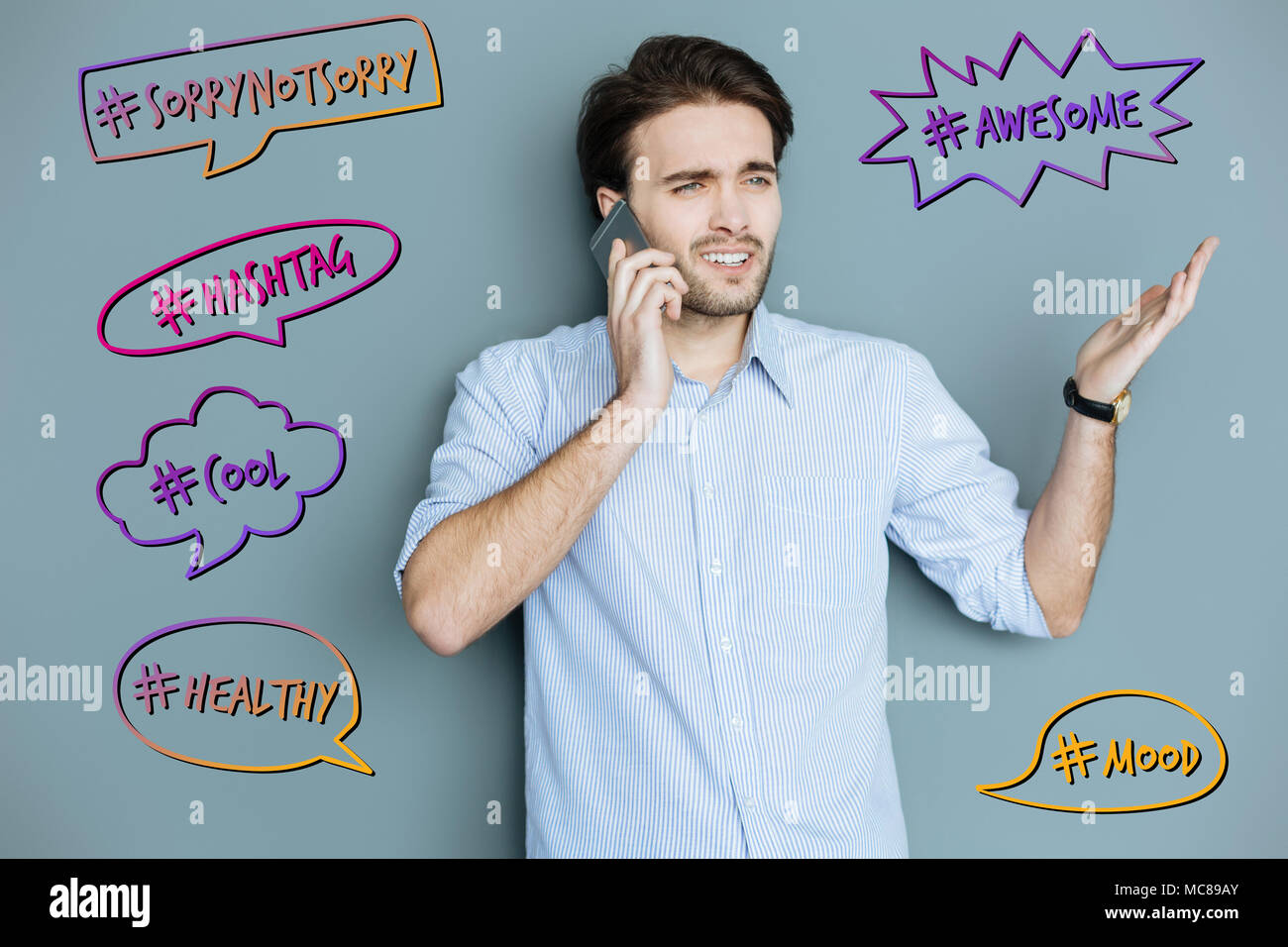Emotional blogger frowning while talking on the phone Stock Photo - Alamy